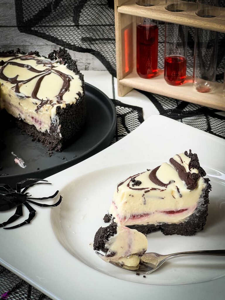 Spooktacular Cheesecake with "Bloody" Raspberry Filling